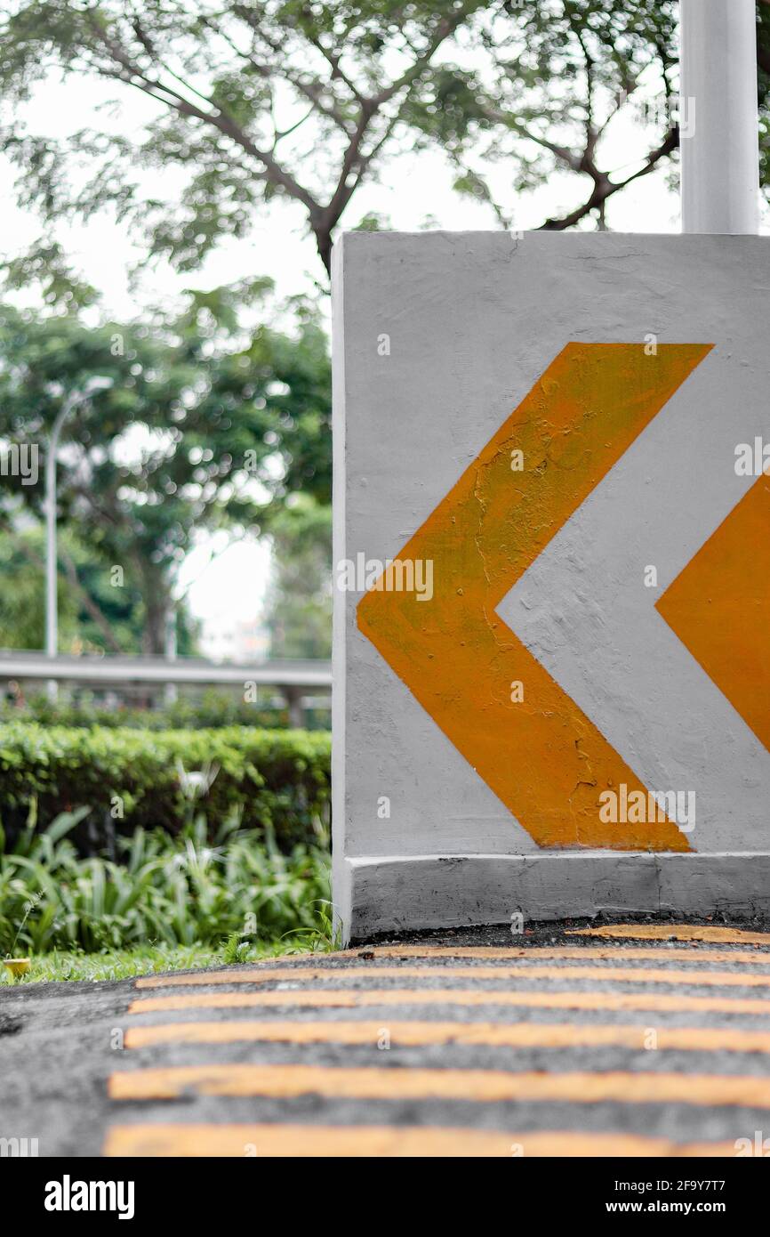 Closeup of the yellow-painted direction indicator arrows on the wall on ...