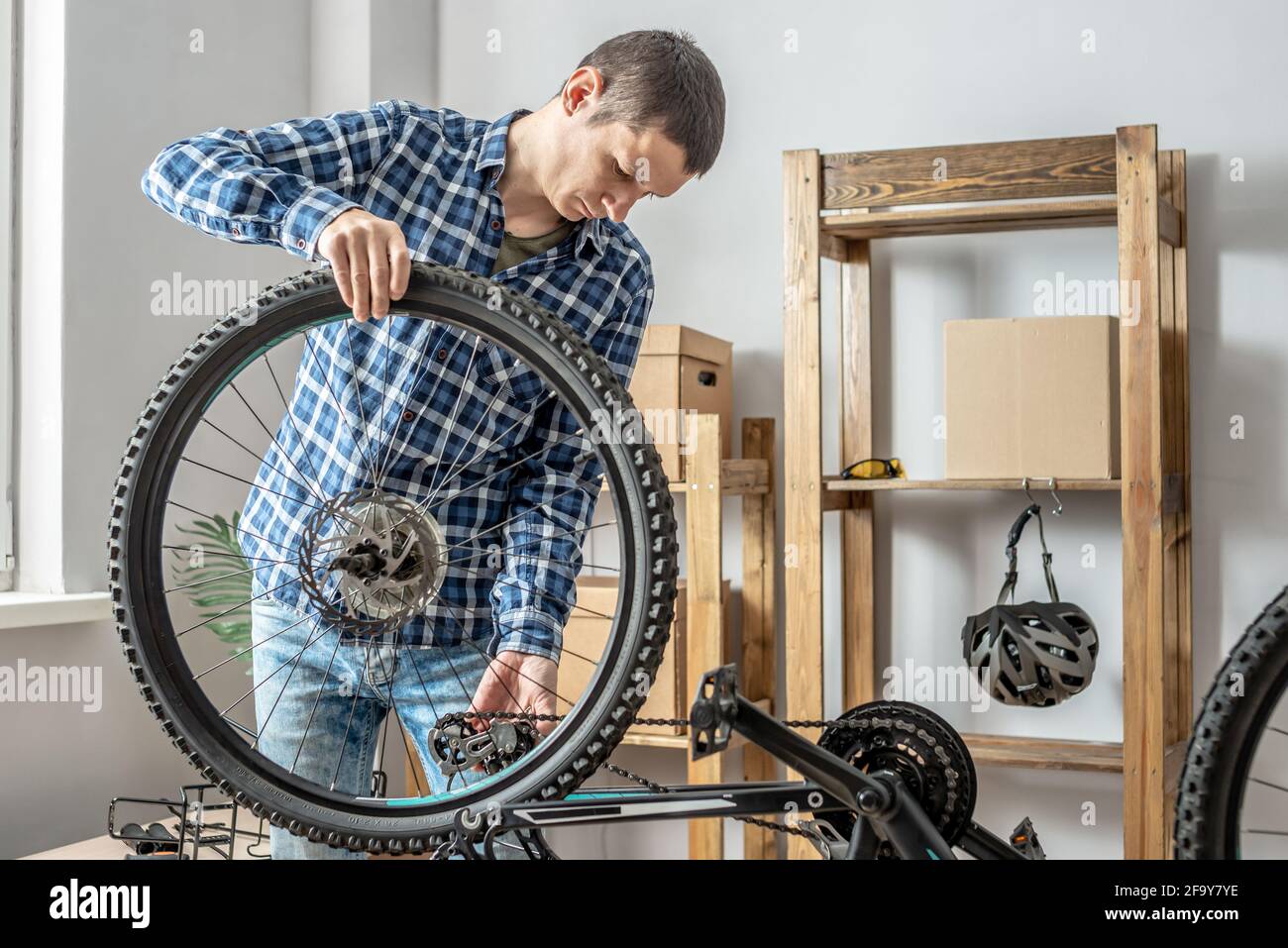 A man is disassembling a mountain bike for maintenance. Concept of ...
