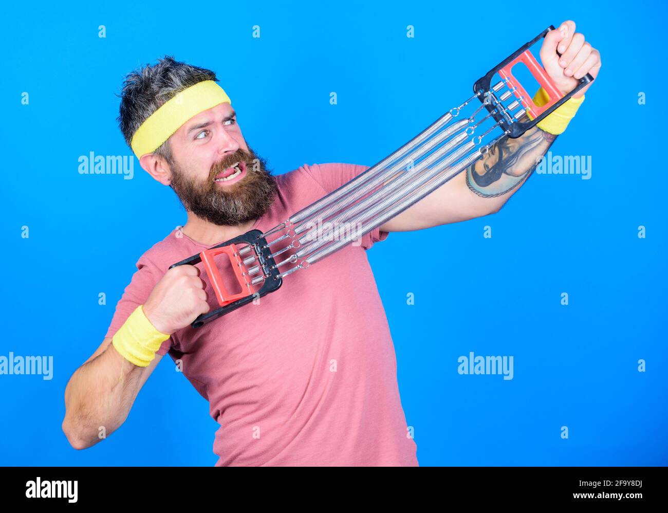 Man bearded athlete exercising with expander. Guide use expander proper ...