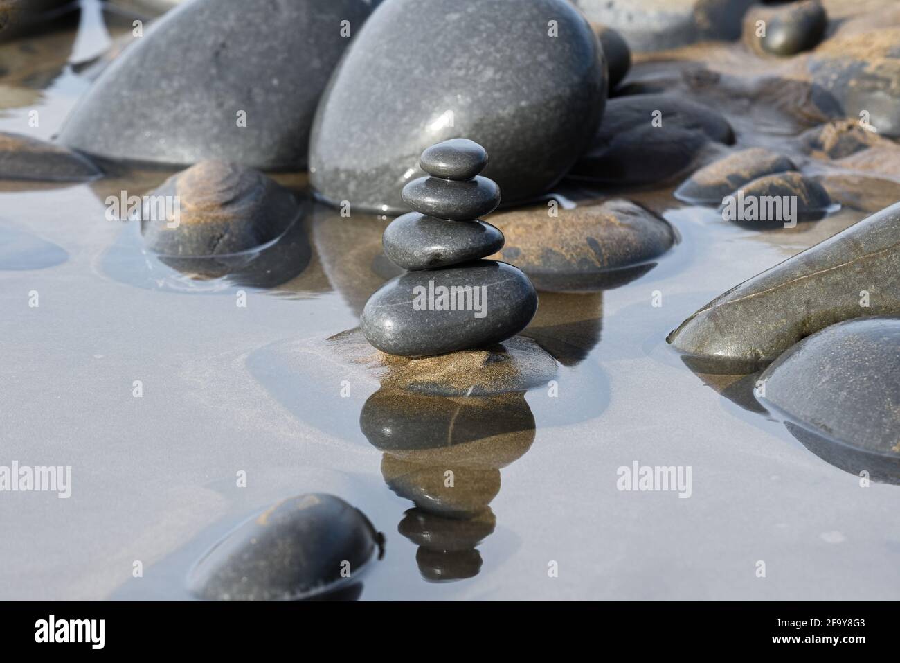 Pebble stack on the beach the stones represent balance and wellbeing of ...
