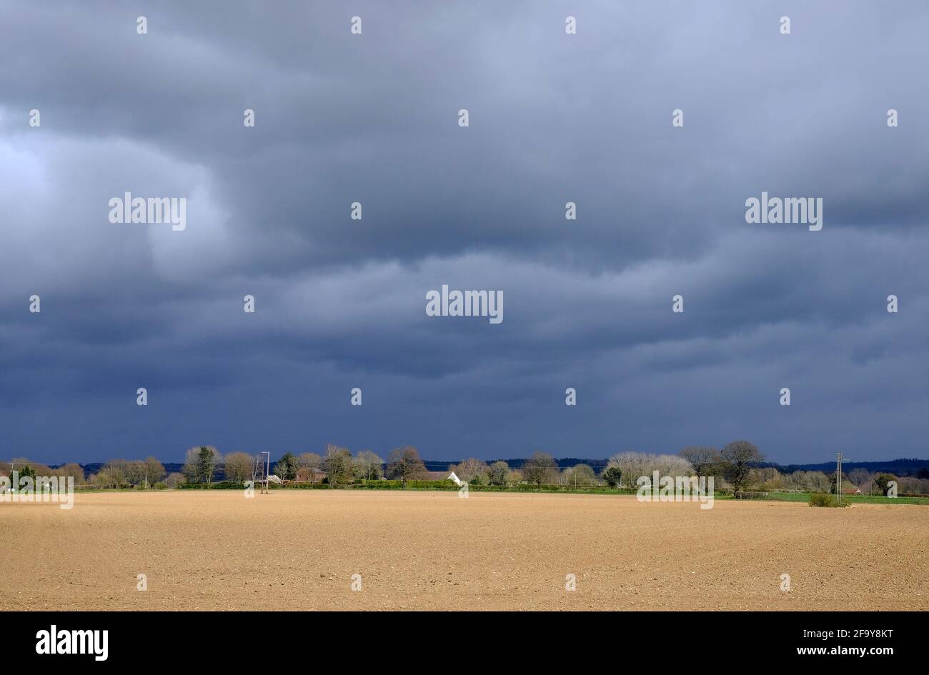 dark rain clouds over countryside, norfolk, england Stock Photo - Alamy