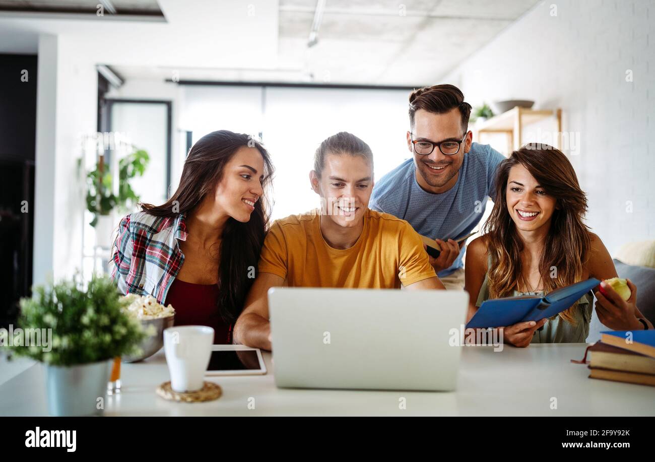 Group of happy young students having fun while studying together for ...