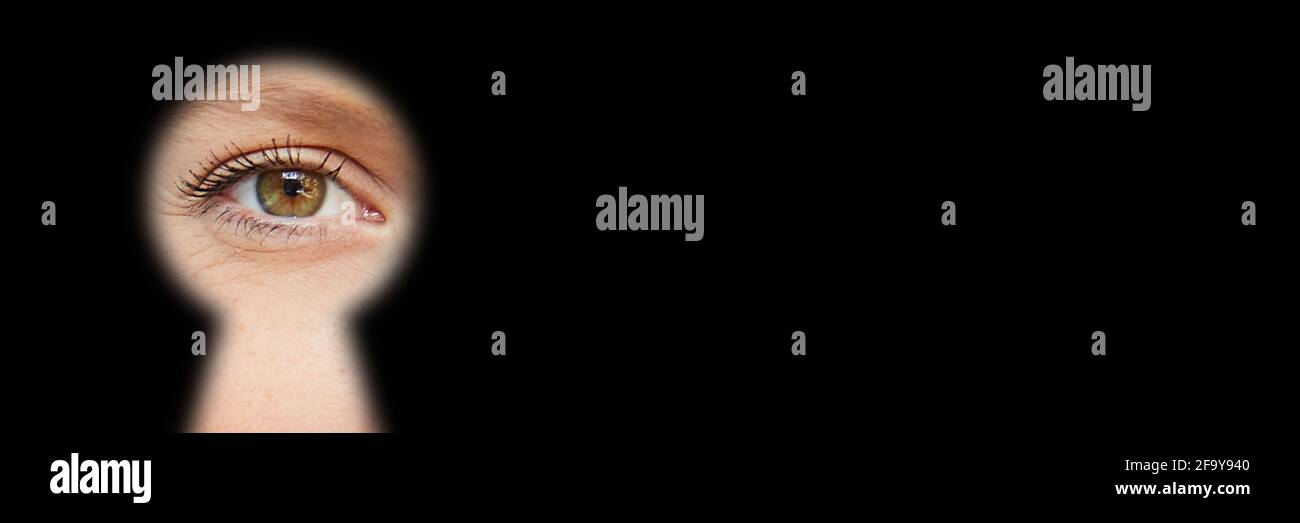 Woman looks through a blurred keyhole as a spy or detective with copy ...