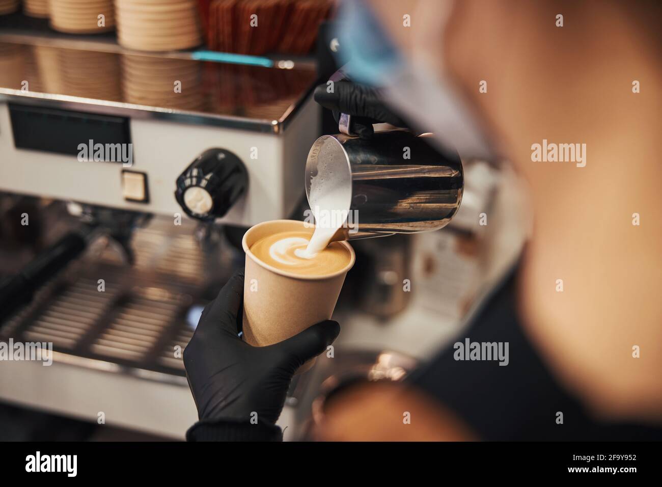 Skillful barista creating a fine pattern on latte surface Stock Photo ...