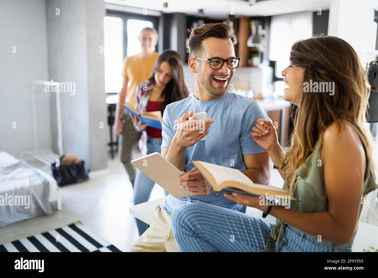 Happy group of students studying and working together in a college ...