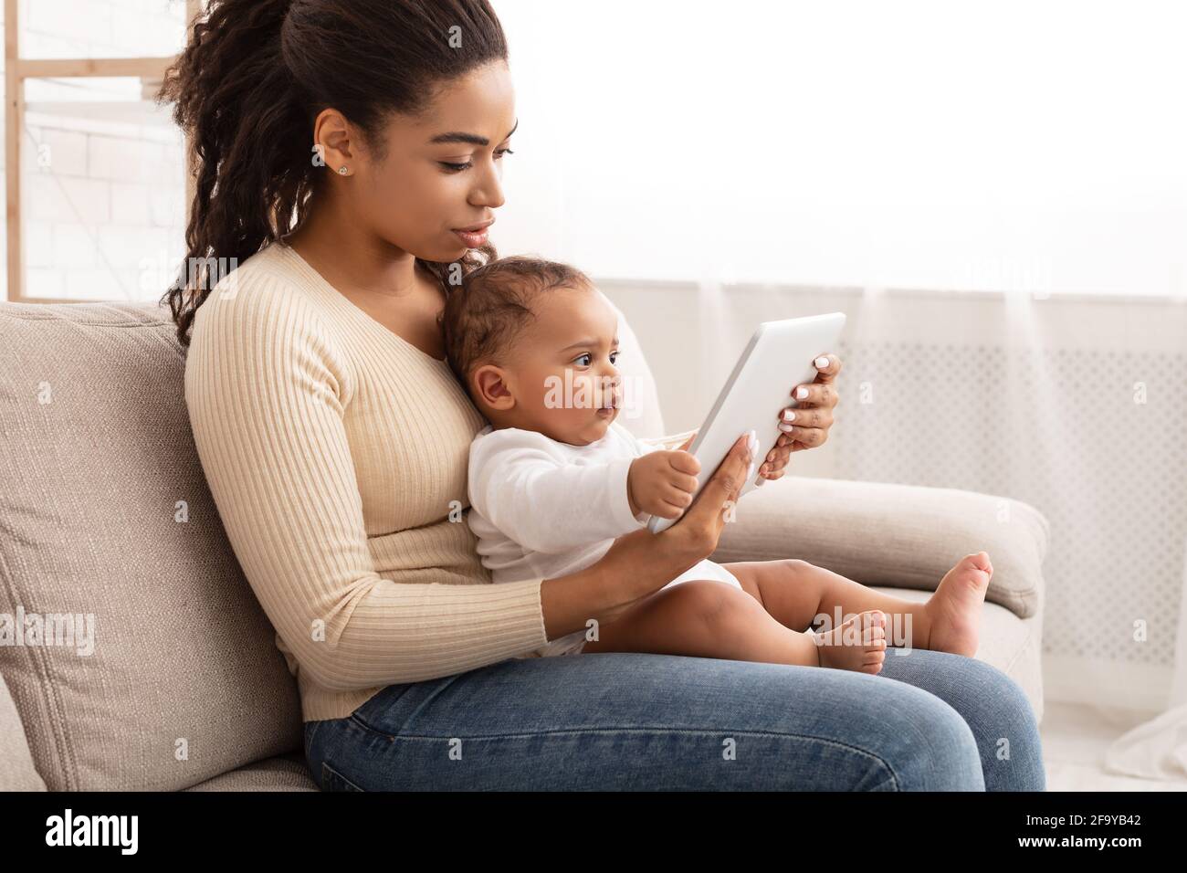 African mother child tablet hi-res stock photography and images - Alamy