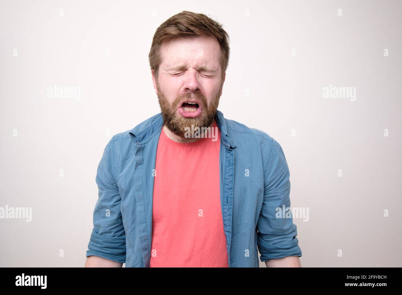Caucasian bearded man is upset, he cries and looks sad. White ...