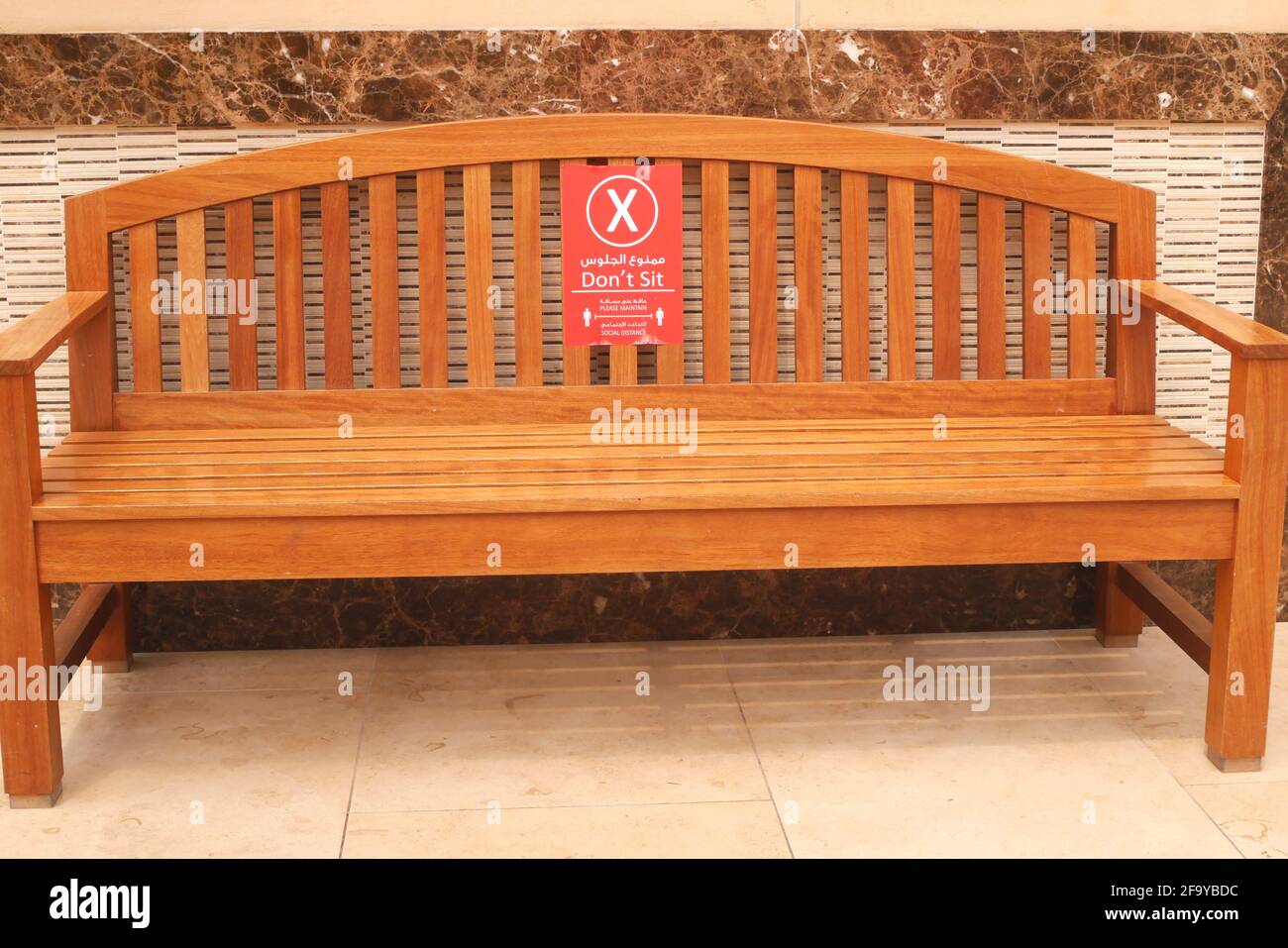 A ‘don’t sit’ Covid 19 warning sign on a bench at The Avenues Mall ...