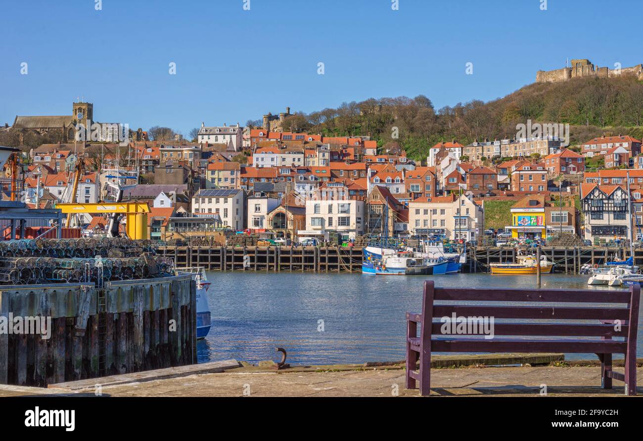 A seaside town is set on a hillside leading up from the harbour below ...