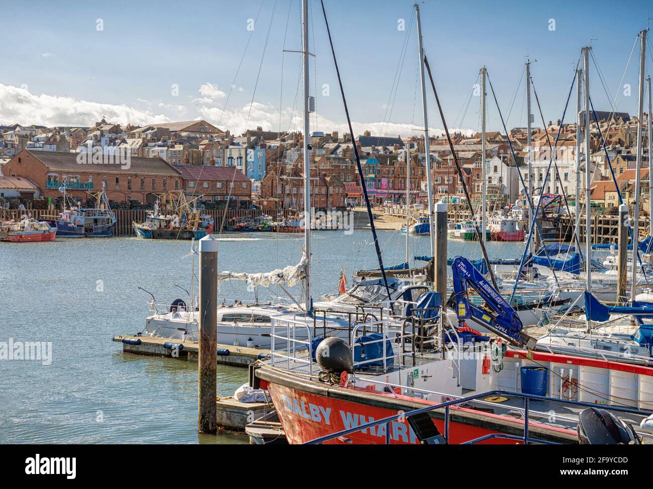 An offshore supply vessel is moored in the foreground of an harbour ...