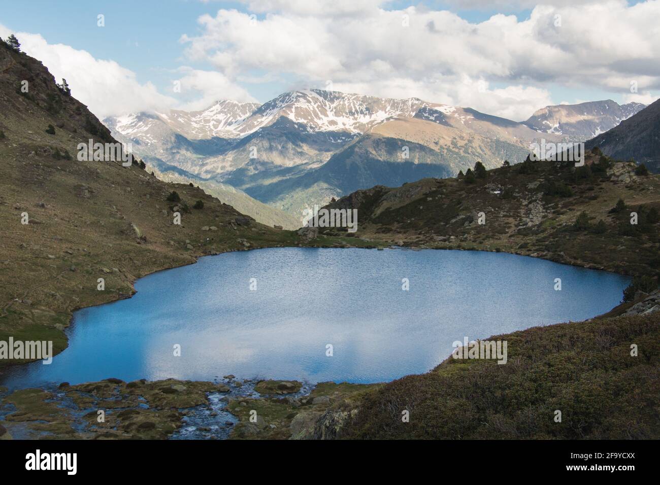 lake between snowy mountain Stock Photo - Alamy