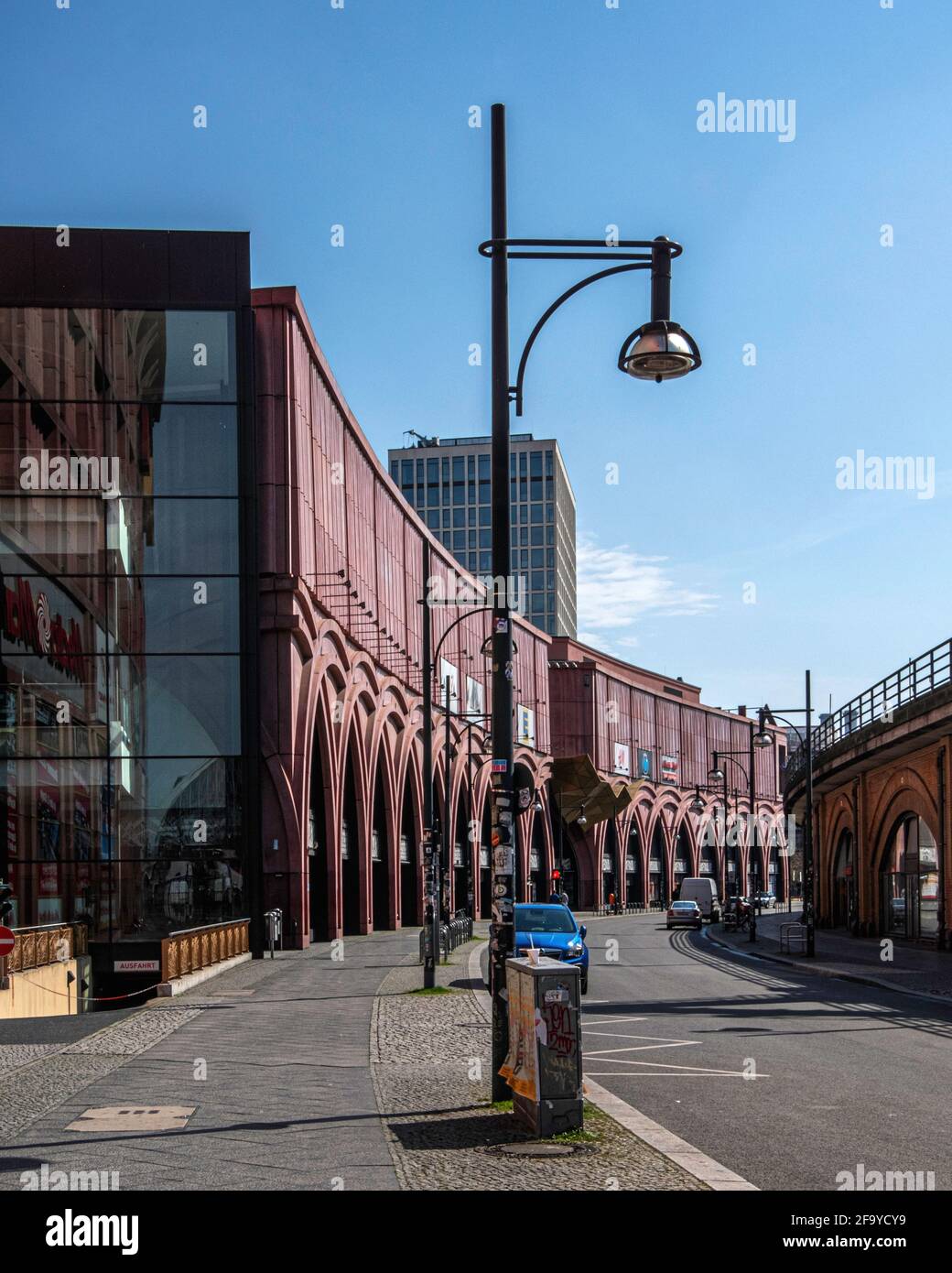 Street lined with Pink arcaded building of the Alexa shopping centre ...