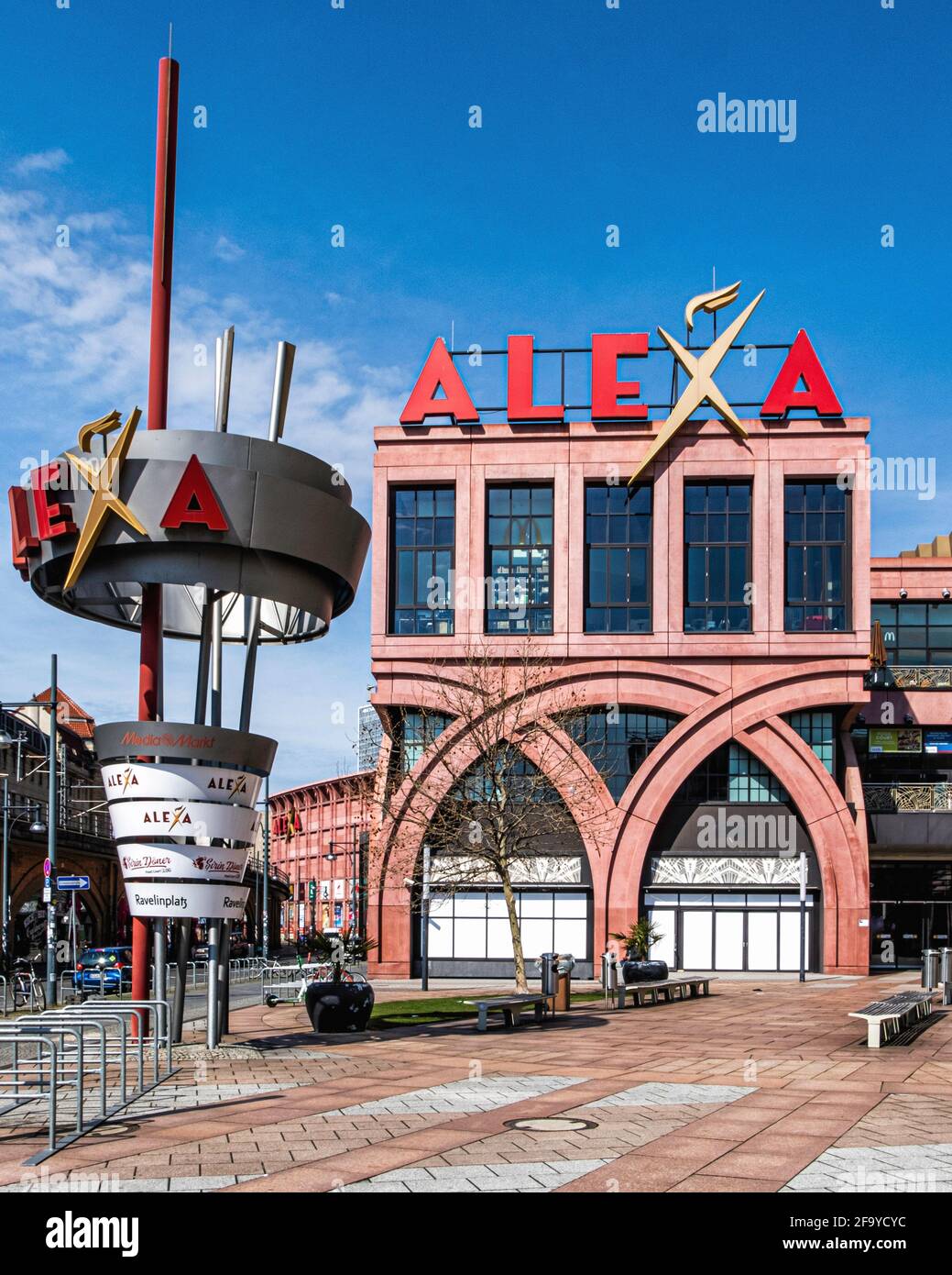 Street lined with Pink arcaded building of the Alexa shopping centre ...