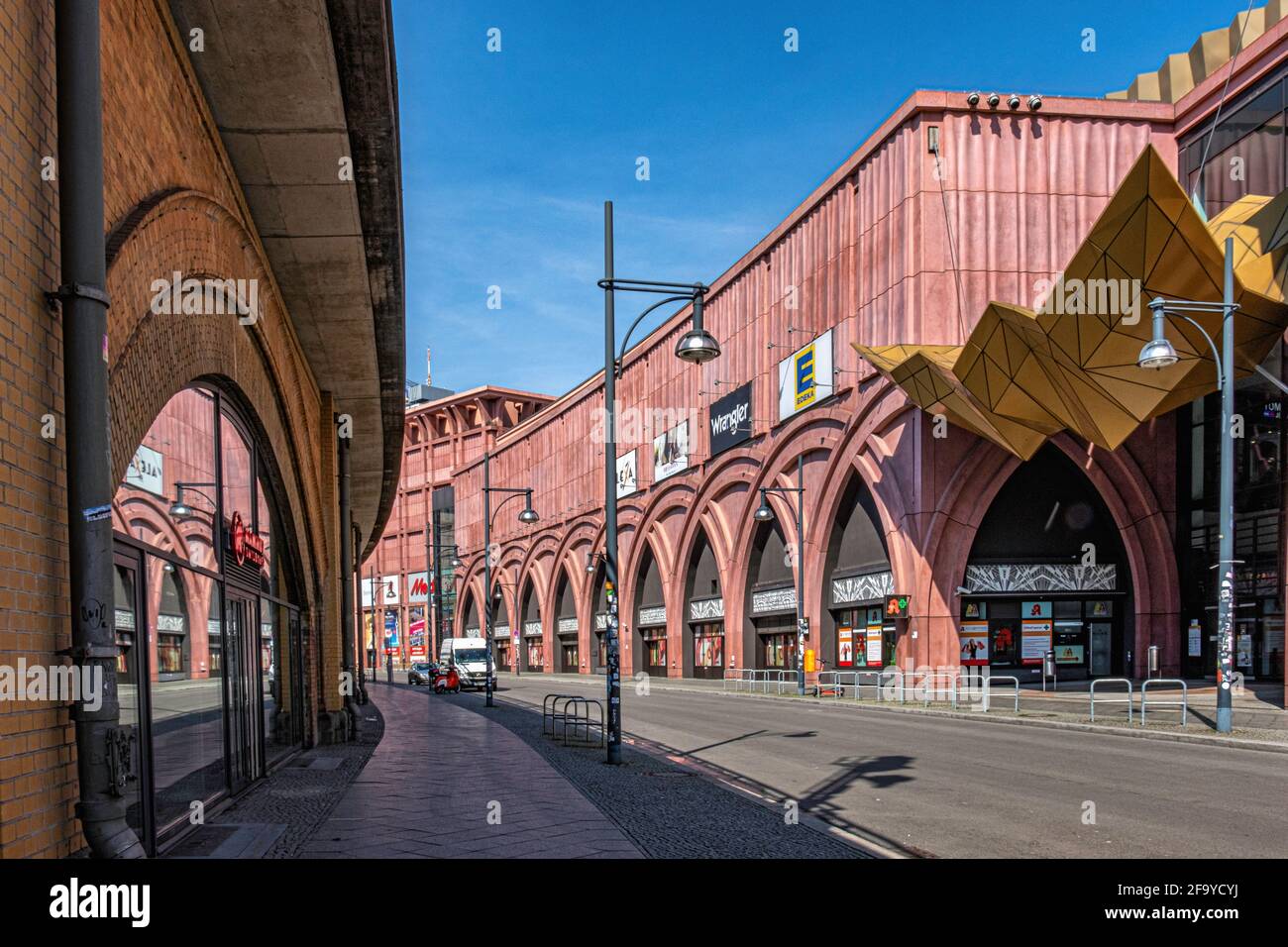 Street lined with Pink arcaded building of the Alexa shopping centre ...