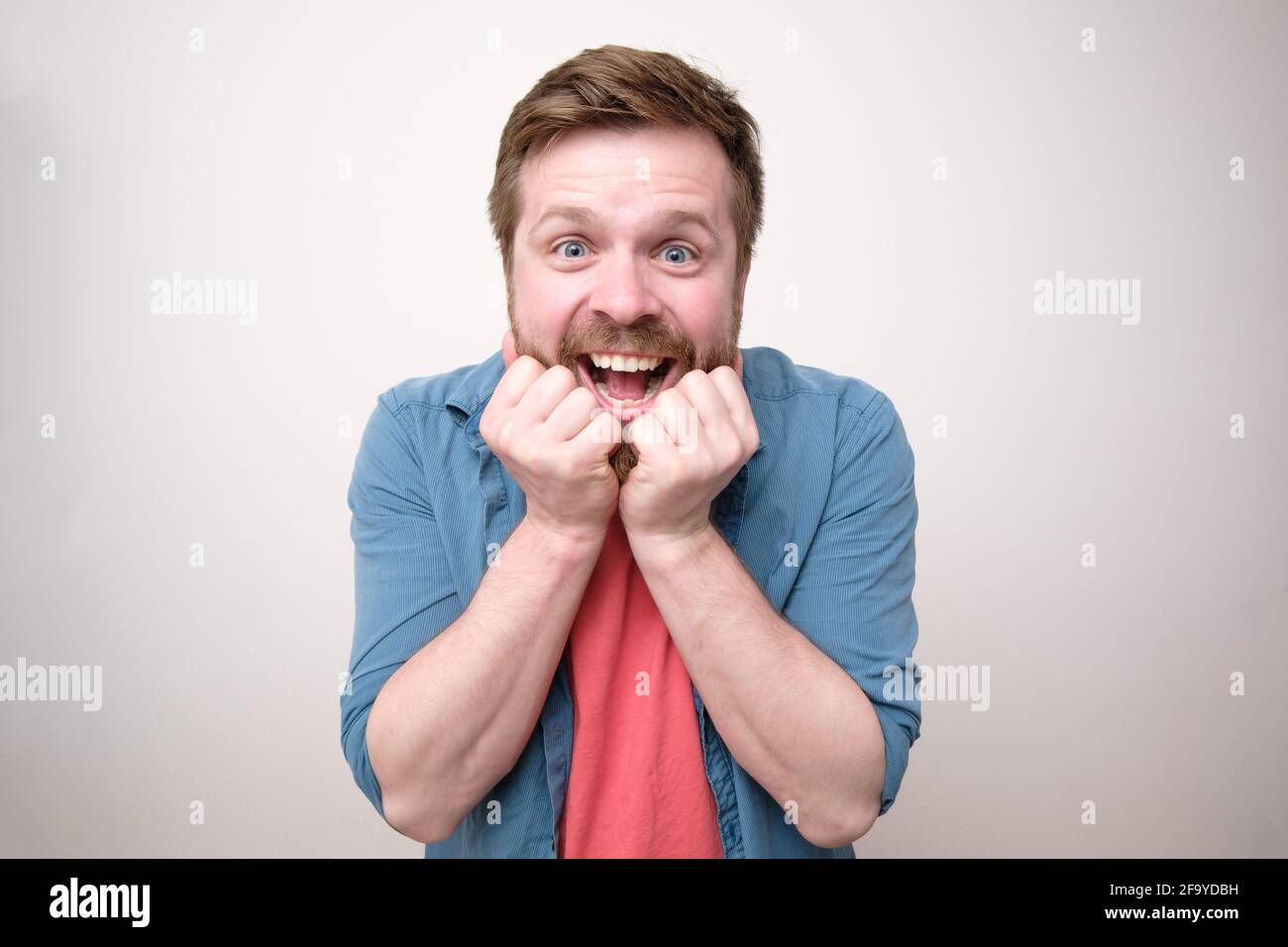 Happy Caucasian man is very surprised by a pleasant surprise, he ...