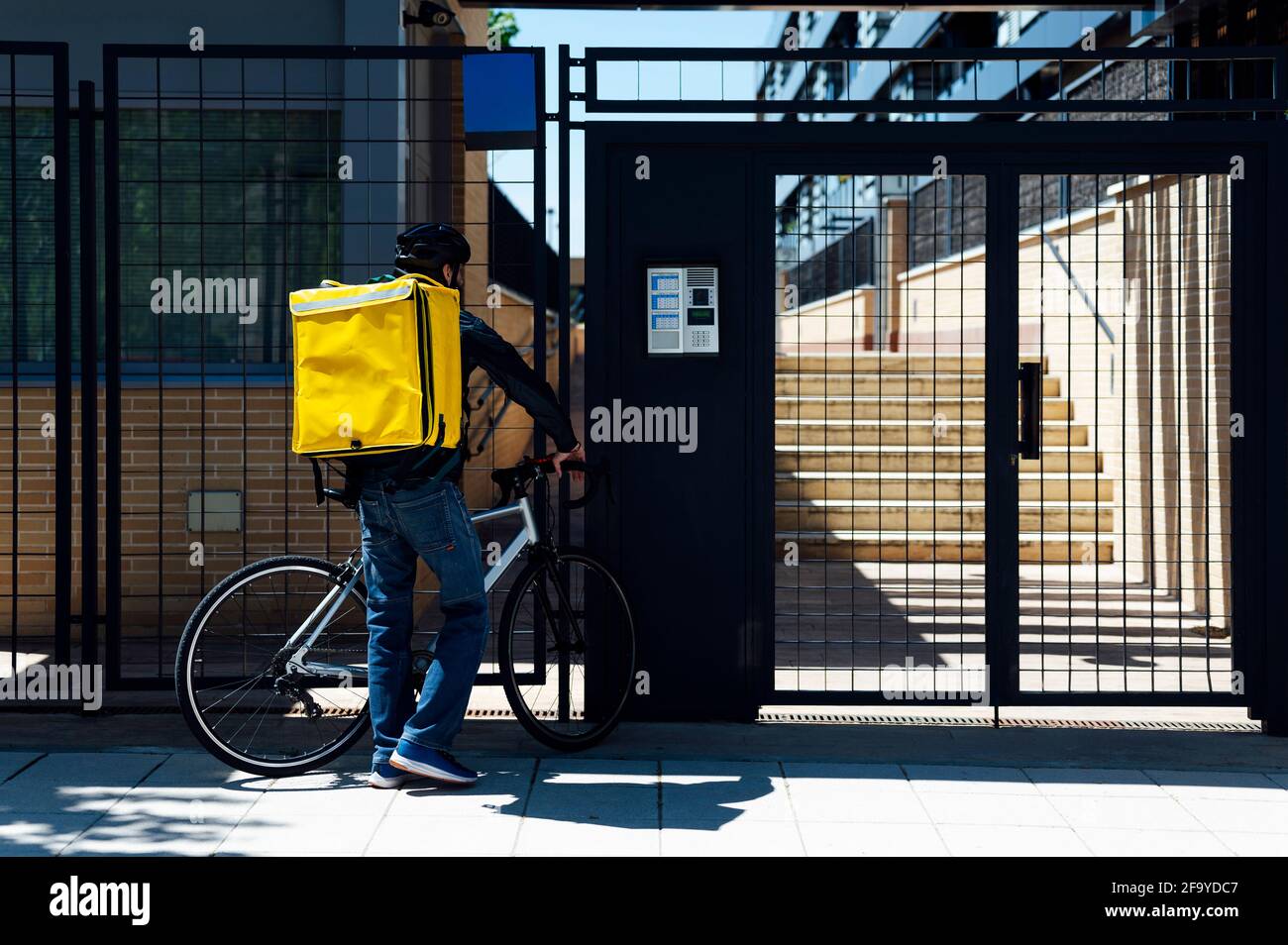 delivery man on bicycle arriving home Stock Photo - Alamy