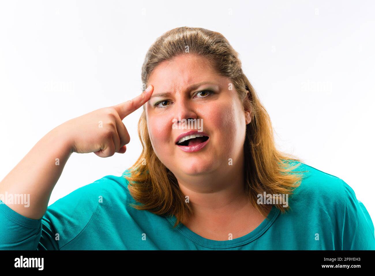 Portrait of woman touching her forehead with finger against white ...