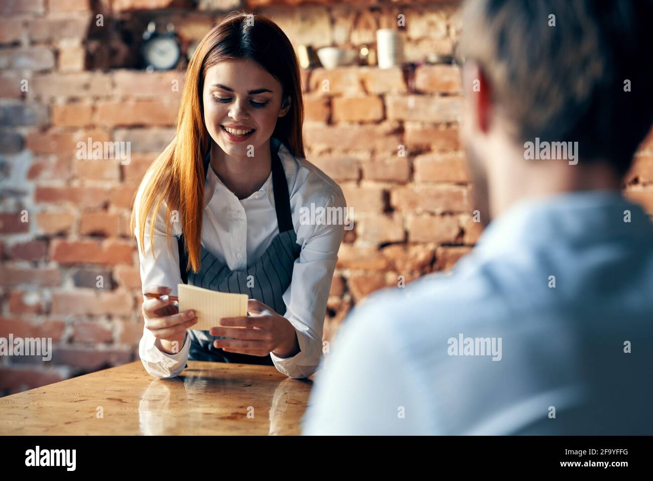 the waiter takes the order from the client communication professional ...
