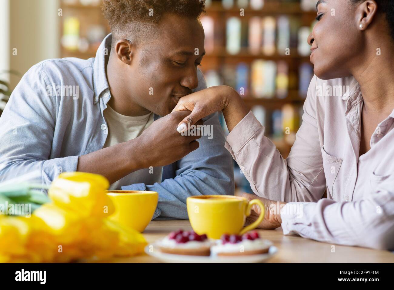 Man kissing hand girlfriend restaurant hi-res stock photography and ...