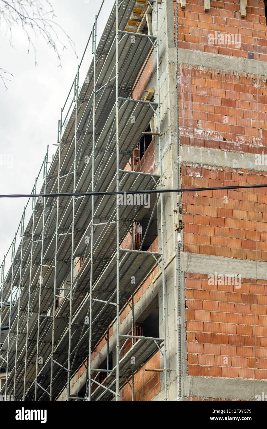 Vertical shot of a brick-walled building under construction Stock Photo ...