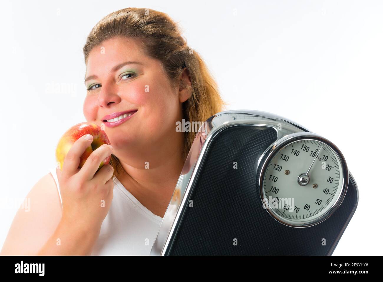 Diet and weight, obese young woman with scale under her arm and apple ...