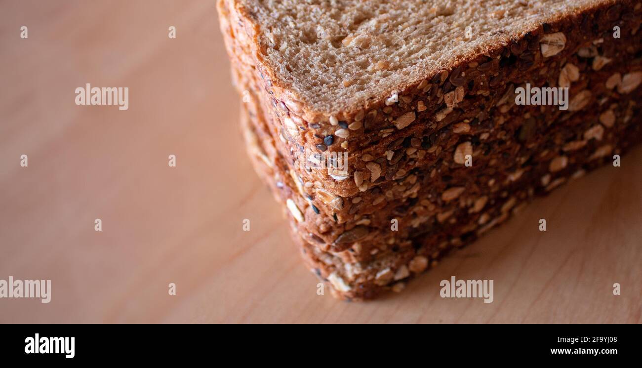 closeup corner slices of fresh baked whole wheat multi grain bread on ...