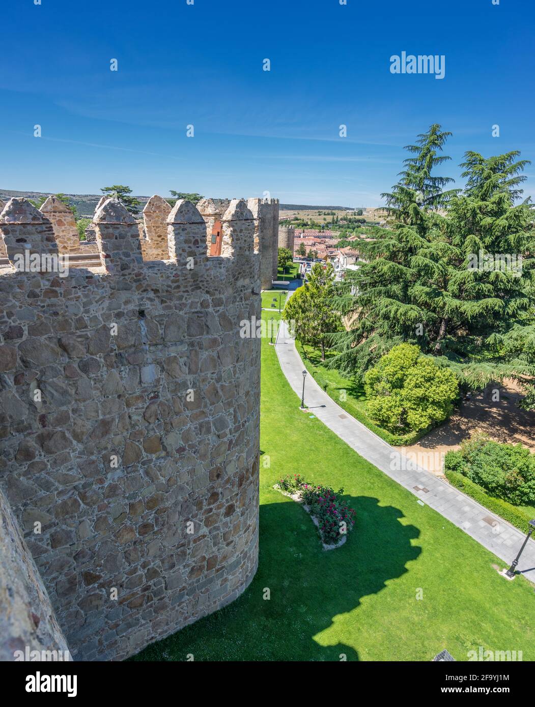 Medieval city walls tower and grass lawn in Avila, Castilla y leon ...