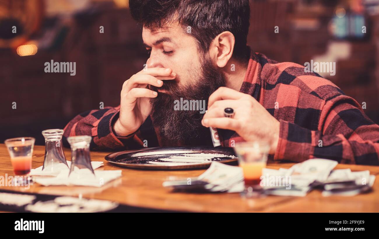 Guy holds rolled banknote, defocused background. Man with busy face ...