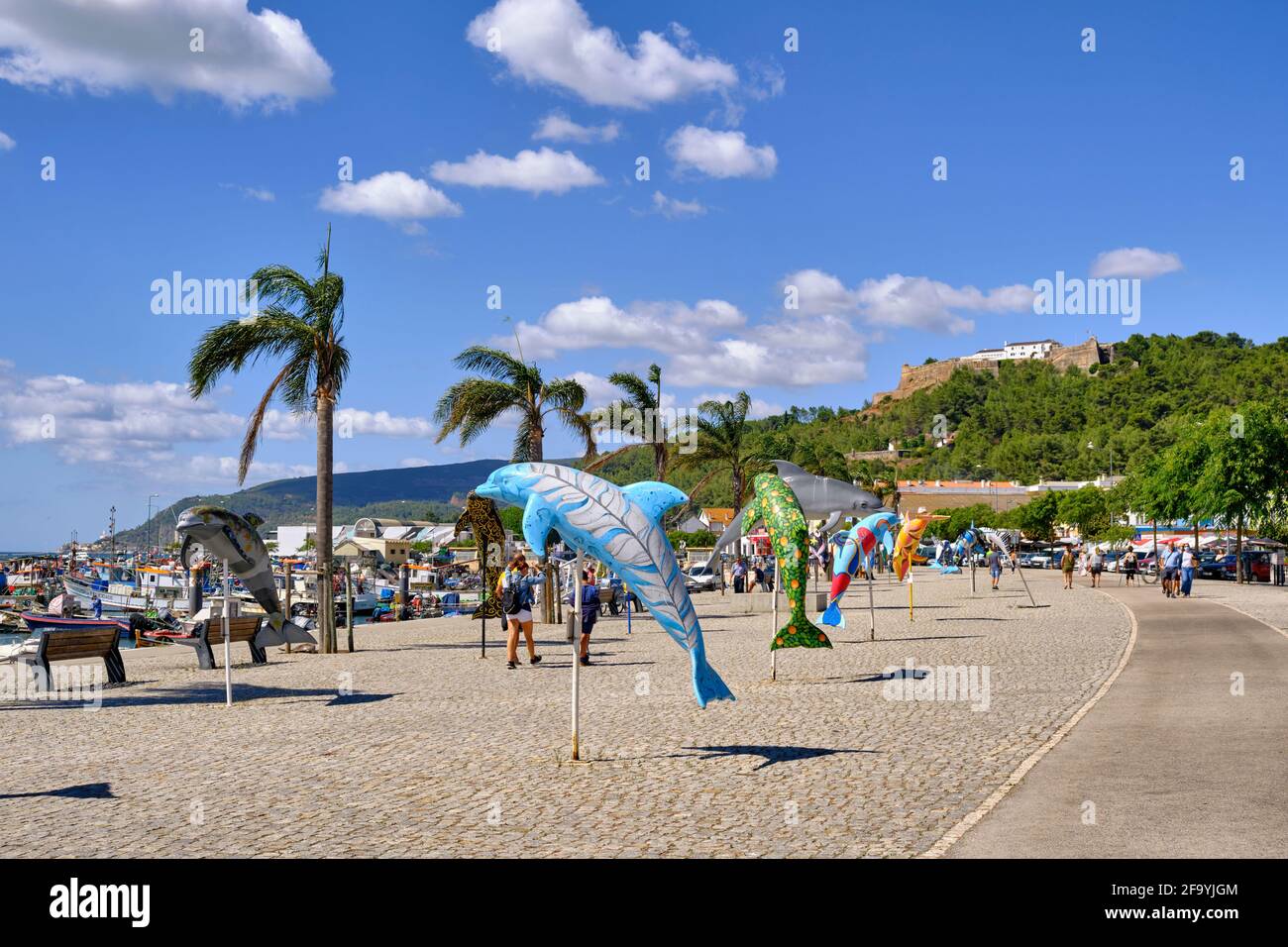 The Dolphins park near the fishing harbour of Setubal. The Sao Filipe ...