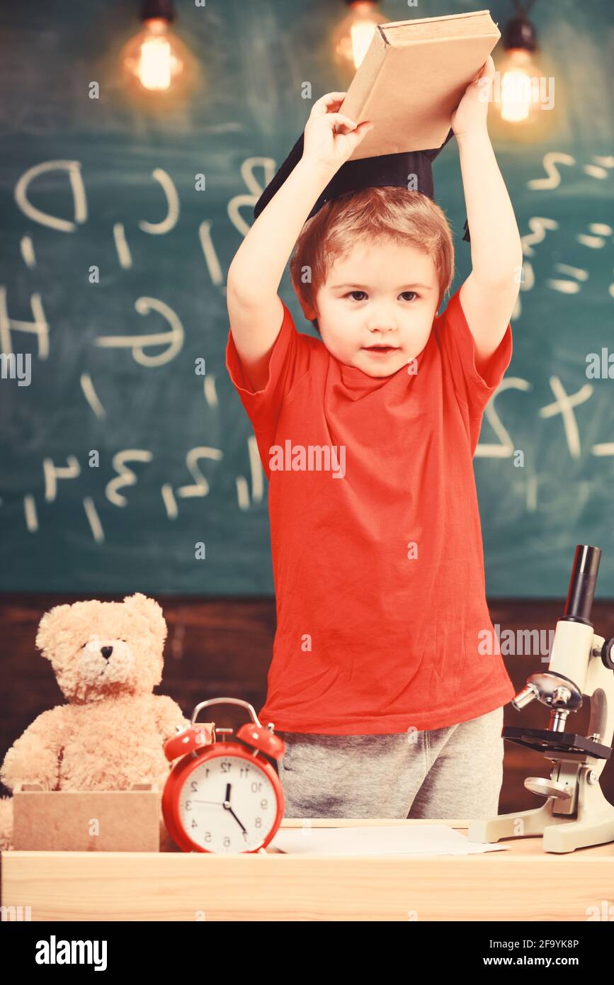 Child, pupil on cheerful face near microscope. Wunderkind concept ...