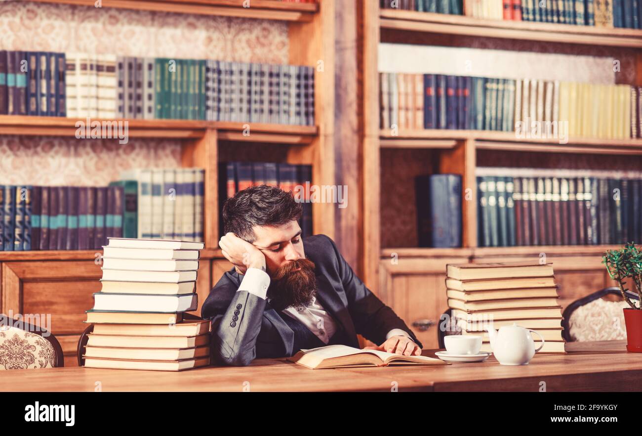Intellectual work concept. Bearded man in library has intellectual work ...