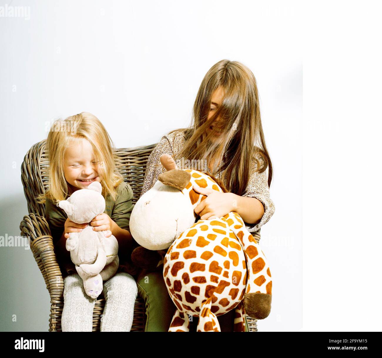 two cute sisters at home interior playing, little happy smiling girl in ...