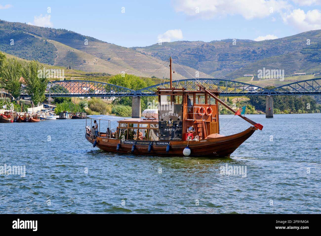 A Douro river tour ship passing along the village of Pinhao. A UNESCO ...