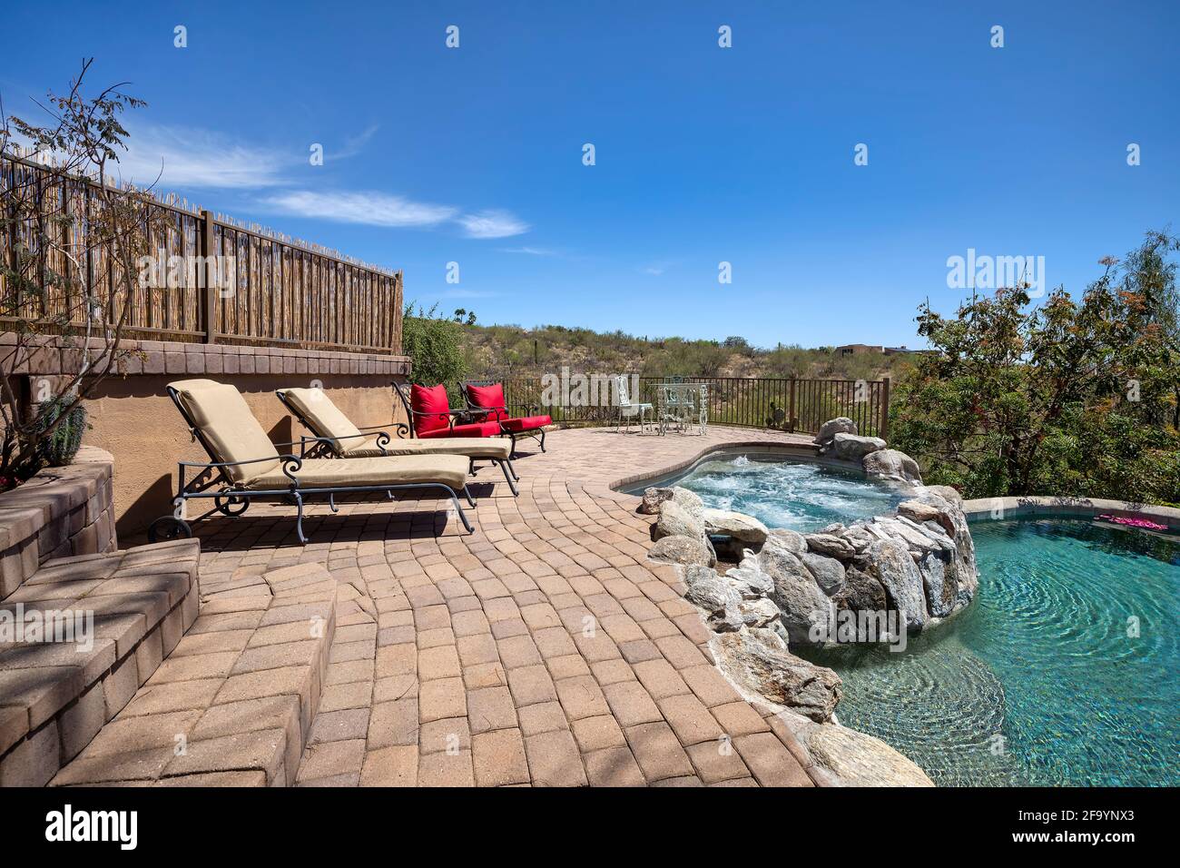 Swimming pool with hot tub and terraced patio at a luxury home in a ...