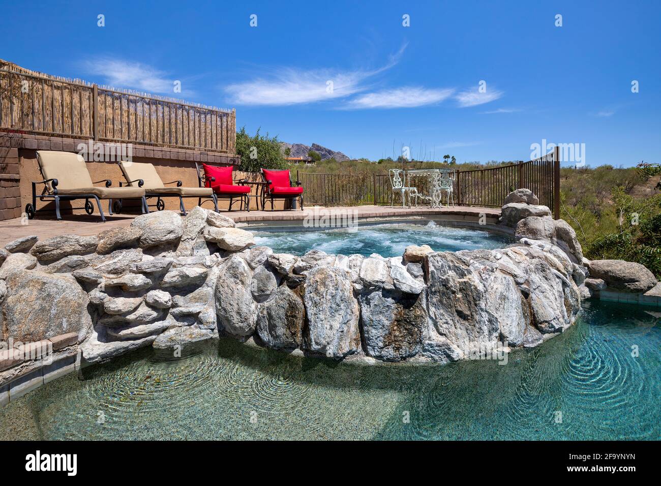 Swimming pool with hot tub and terraced patio at a luxury home in a ...