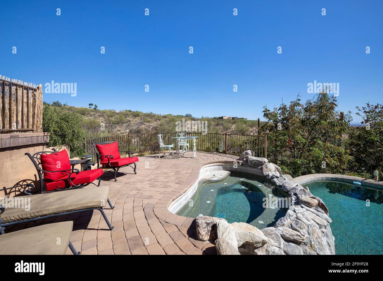 Swimming pool with hot tub and terraced patio at a luxury home in a ...