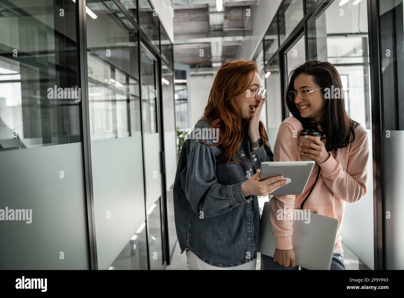 happy and pretty students in glasses laughing in hall Stock Photo - Alamy