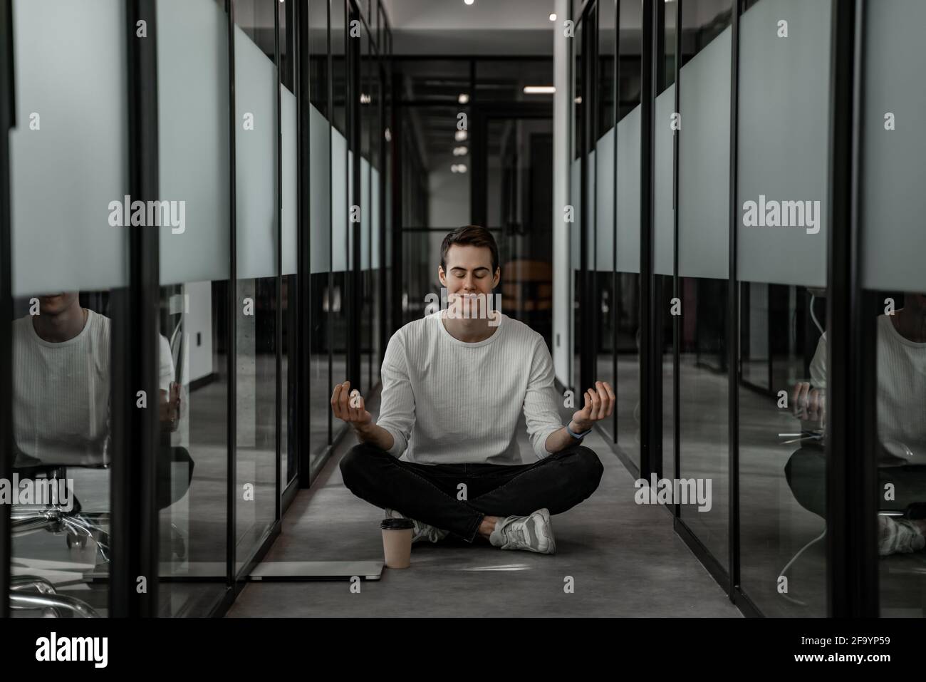 student with closed eyes meditating in hall Stock Photo - Alamy