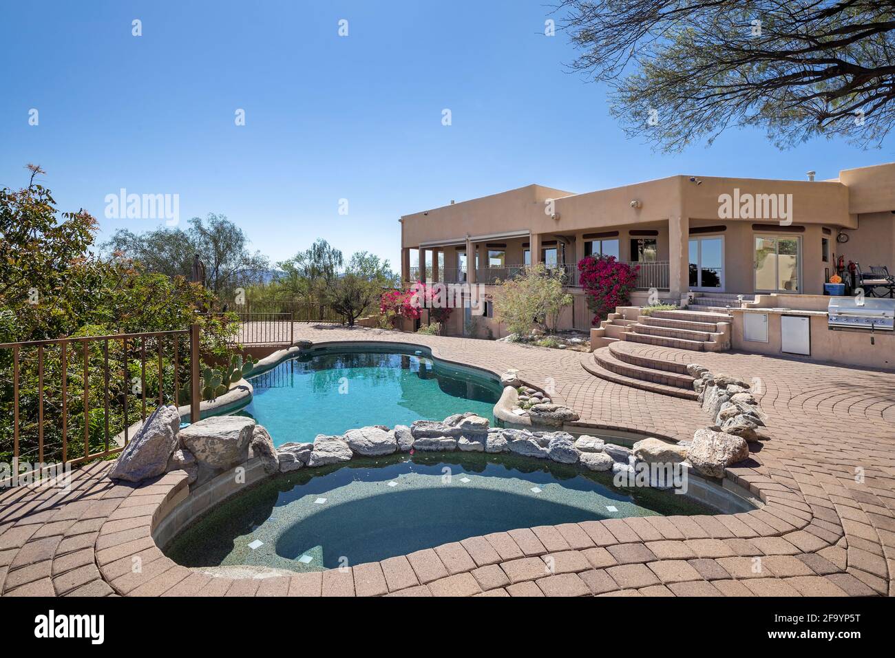 Swimming pool and terraced patio at a luxury home in a desert ...