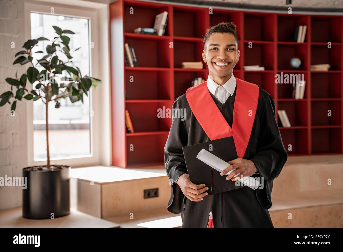 happy african american student in graduation gown holding diploma Stock ...