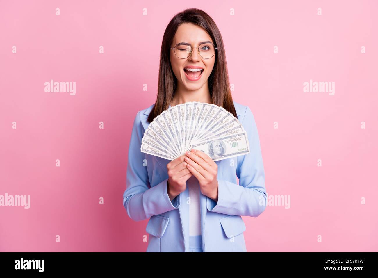Photo portrait of winking girl holding cash fan in two hands isolated ...