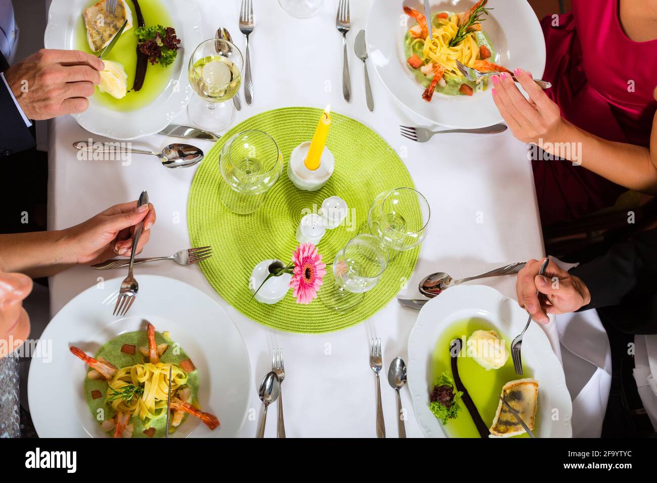 Two couples dining in fine restaurant enjoying the good food Stock ...