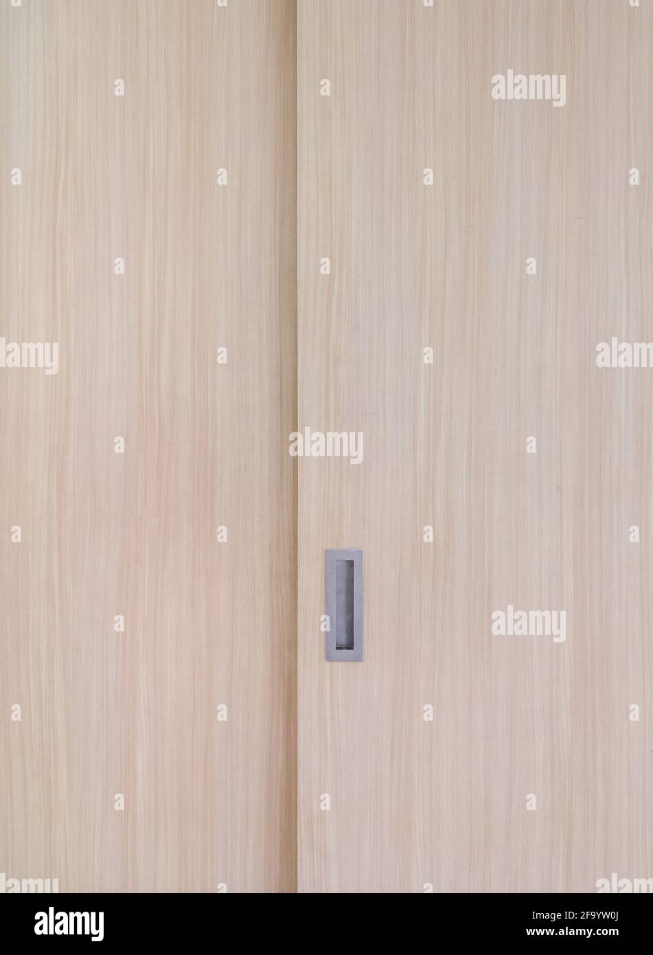 Wooden cabinet slide door with the metal handle in the minimal style ...