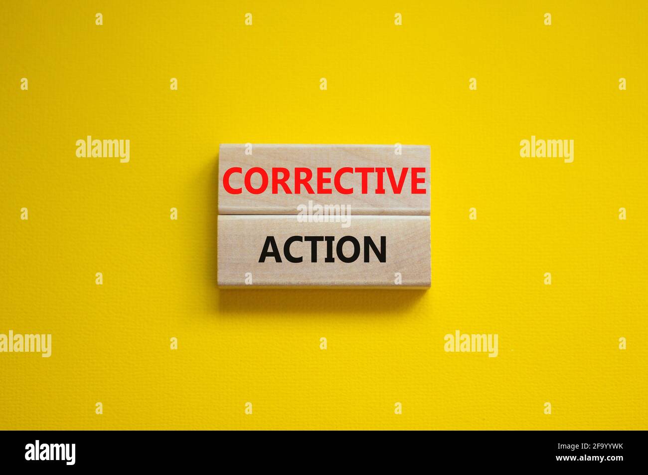 Corrective action symbol. Wooden blocks with words 'Corrective action ...
