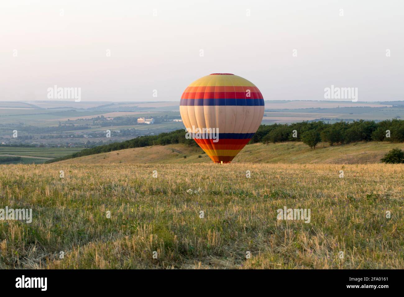 Landing balloon. The balloon lands in a field. Rural landscape Stock ...