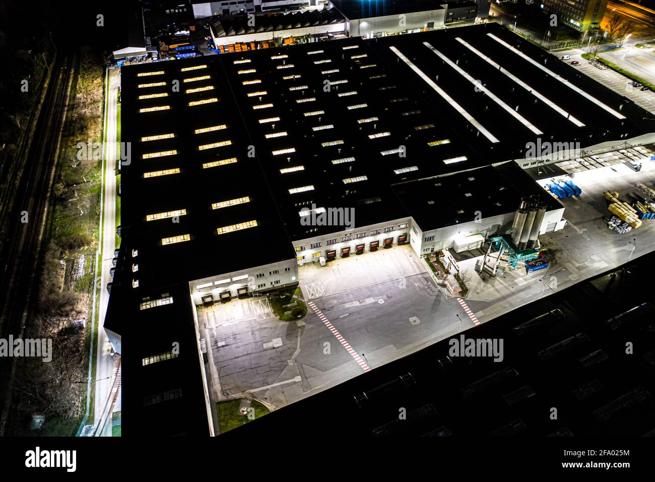 Aerial view of the trucks unloading at the logistic center. Night view ...