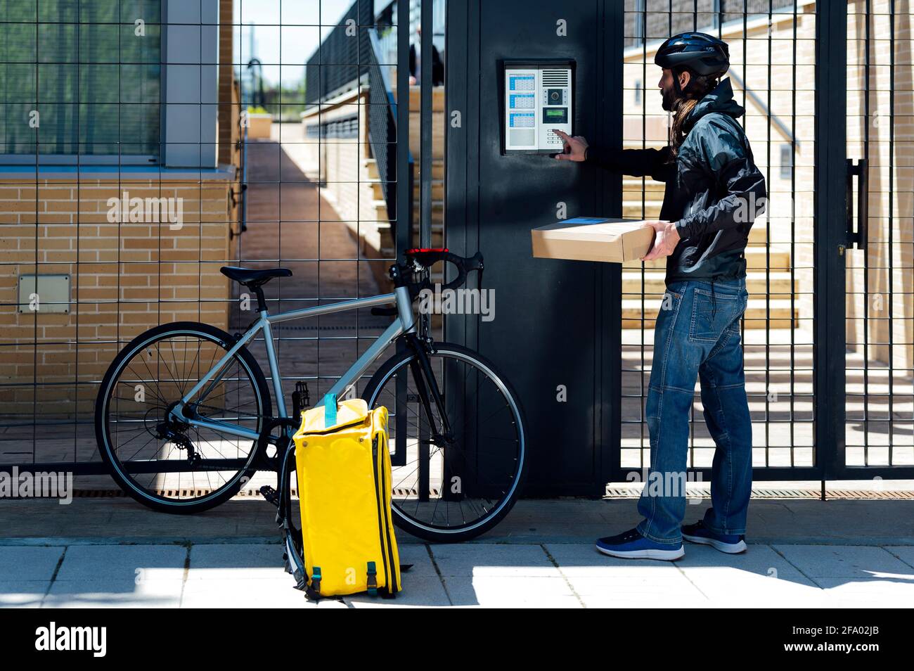 delivery man ringing the bell to deliver the package Stock Photo - Alamy
