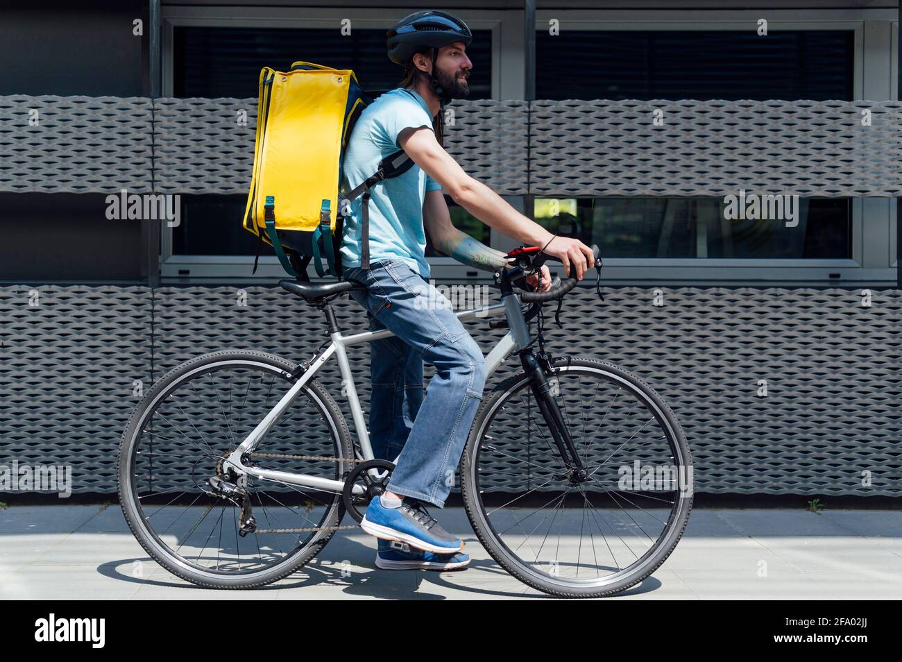 Delivery man with yellow backpack hi-res stock photography and images ...