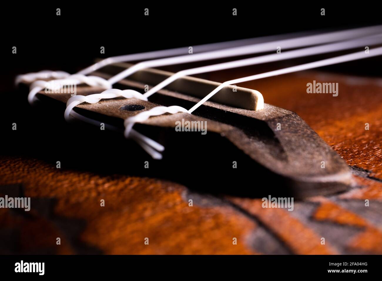 Angled view of ukulele bridge Stock Photo - Alamy