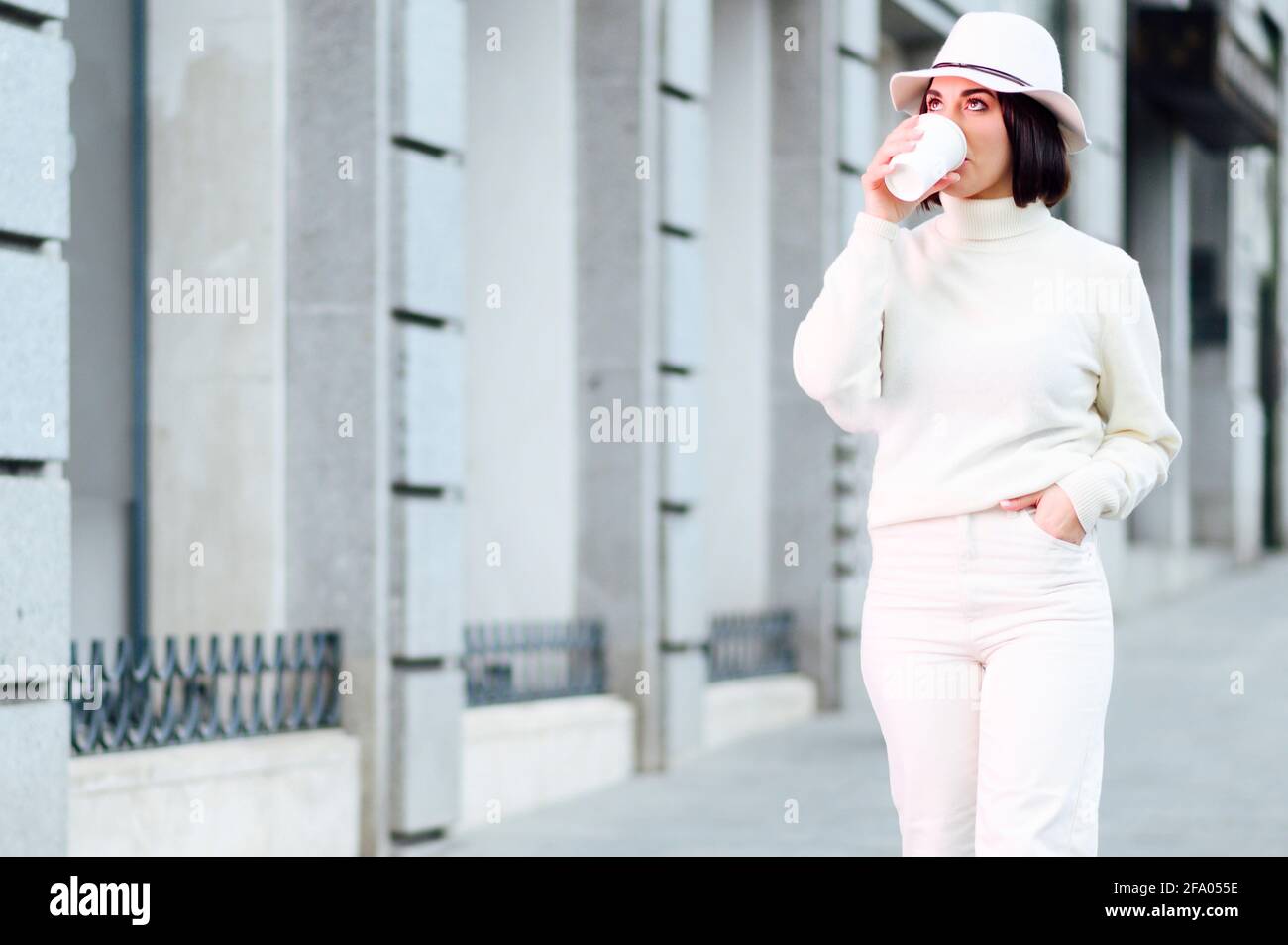 Woman on the street drinking coffee and relaxed Stock Photo - Alamy